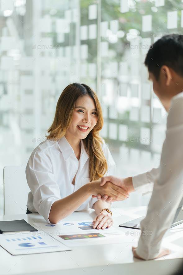 Portrait young Asian woman interviewer and interviewee shaking hands ...