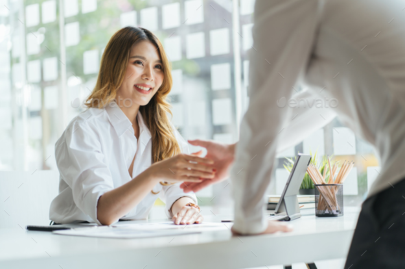 Portrait young Asian woman interviewer and interviewee shaking hands ...