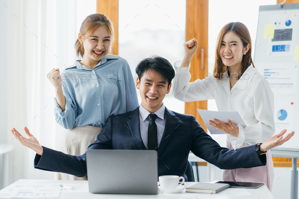 Solving problems as one team. Asian young team of male and female ...