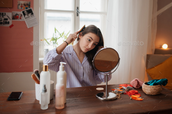 Teenage girl doing her skin care routine and hairstyle. Stock Photo by ...