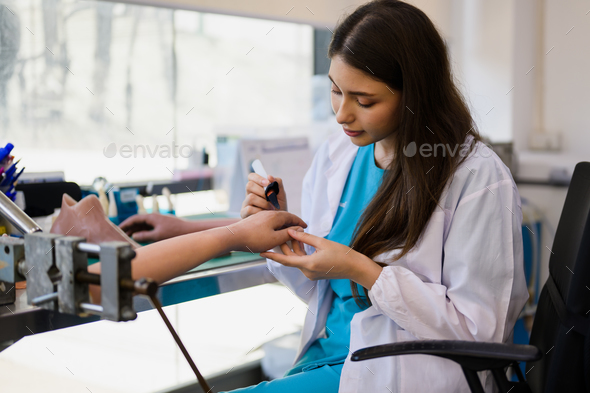 Technician making and checking prosthetic limb at prosthetic workshop ...