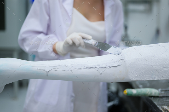 Prosthetic technician sculpting plaster cast for socket at factory Stock Photo by 1footage