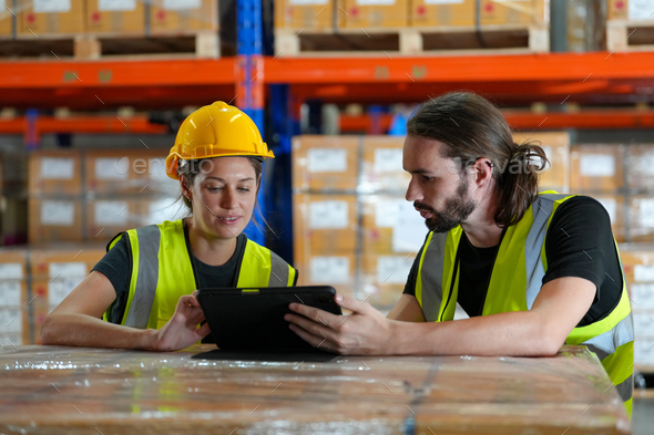 Young warehouse workers working together. Business distribution supply ...