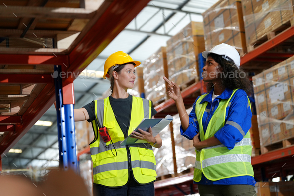Young warehouse workers working together. Business distribution supply ...