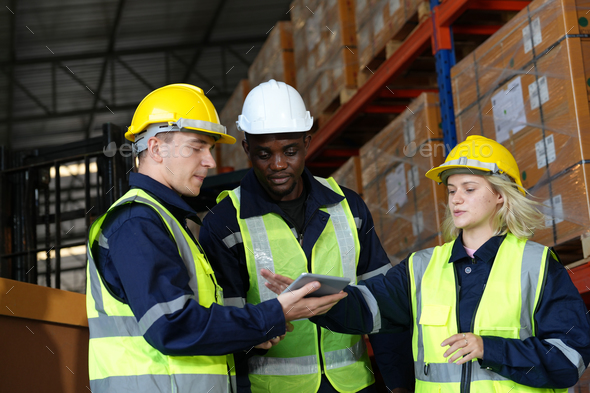 Young warehouse workers working together. Business distribution supply ...