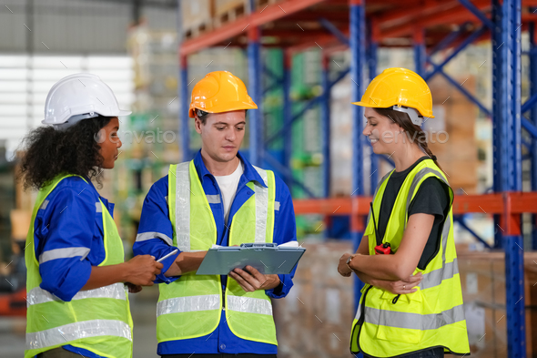 Young warehouse workers working together. Business distribution supply ...