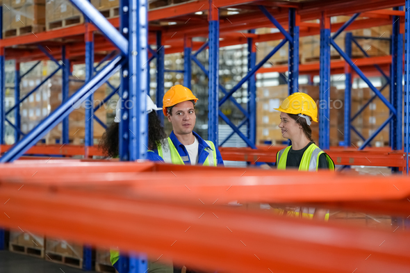 Young warehouse workers working together. Business distribution supply ...