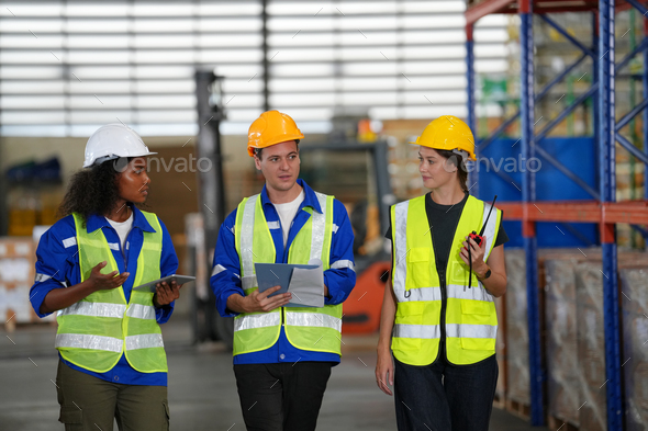 Young warehouse workers working together. Business distribution supply ...
