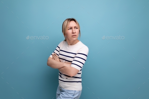 serious sullen blond girl on a blue background with copyspace Stock ...