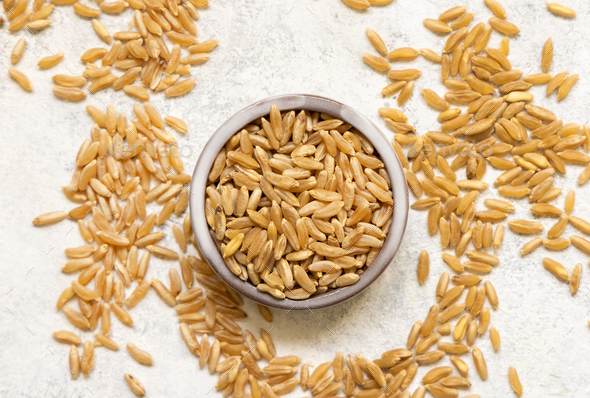 Bowl of raw dry rye grain on white table top view Stock Photo by ...