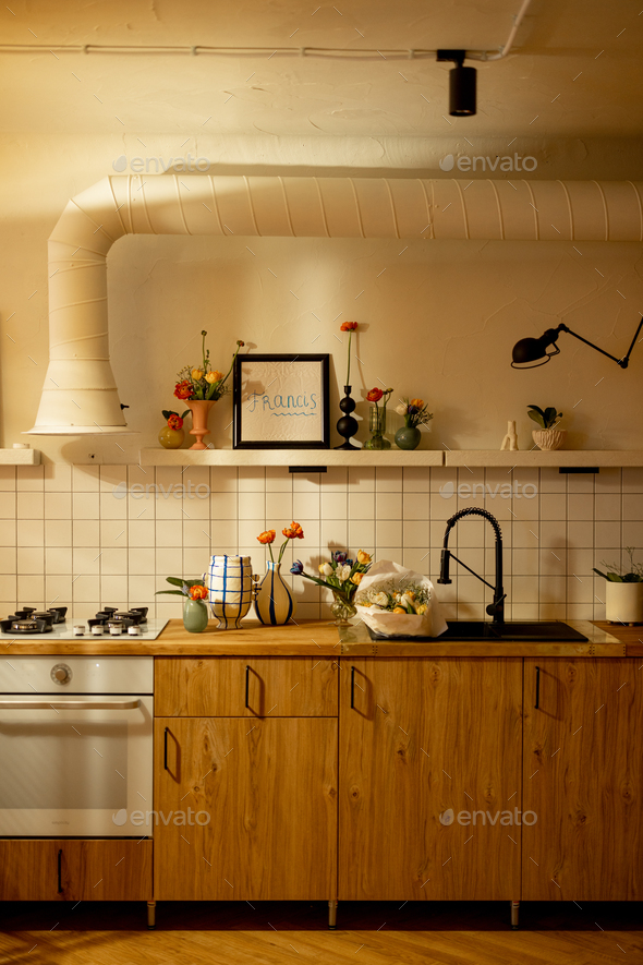 Modern kitchen interior decorated with flowers Stock Photo by RossHelen