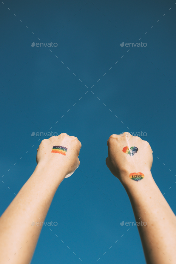 Fists raised in the colors of the rainbow symbol of diversity, lgtb ...