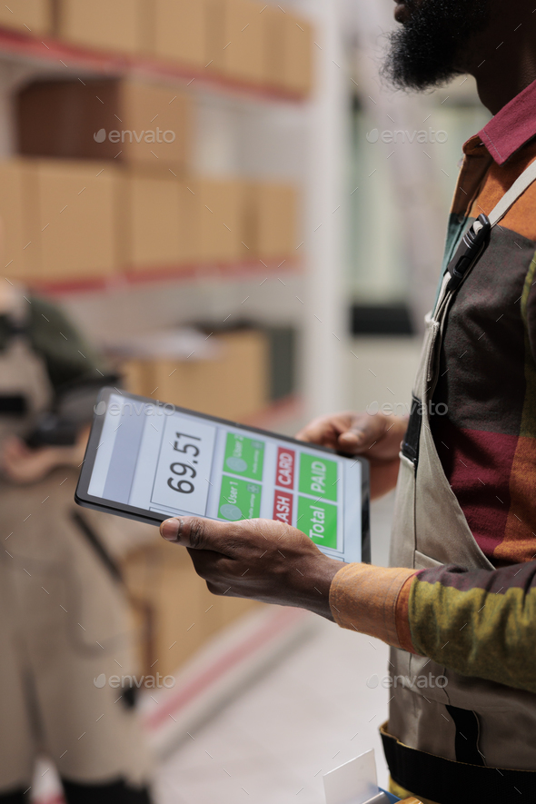 Worker holding tablet computer checking inventory report Stock Photo by ...