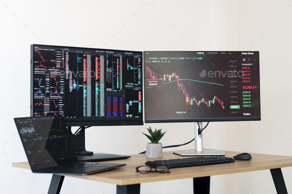 Computer monitors, laptop with trader charts on the desk Stock Photo by ...