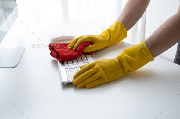 Close up view of man cleaning keyboard computer using clothes. Cleaning ...