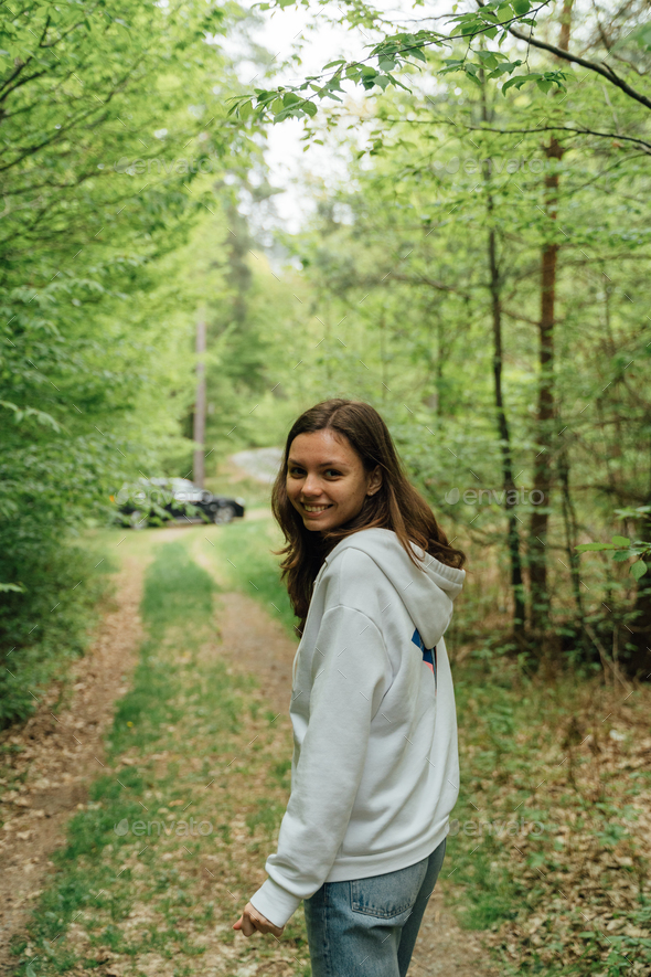 teenager gen z girl walking in the forest. close to nature concept ...