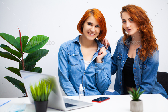 Two girls work together as a team in the company office Stock Photo by ...