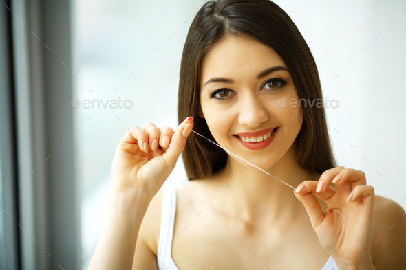 Teeth Care. Beautiful Smiling Woman Flossing Healthy White Teeth. High ...