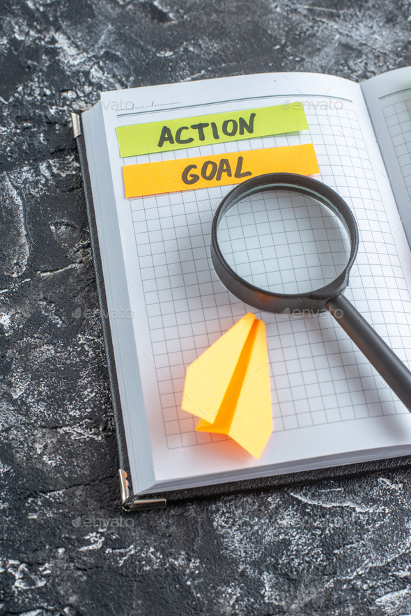 front view open copybook with notes and magnifier on gray background ...