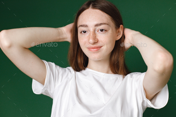 Studio portrait of a girl model isolated on green background Stock ...