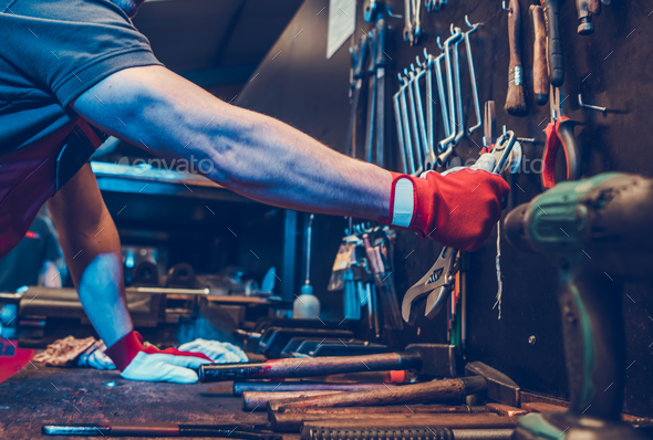 Industrial Worker Grabbing His Work Tools From Storage Wall Stock Photo ...