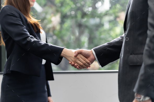 A handshake between a Japanese male businessman and a female ...