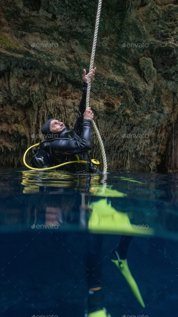 underwater split shot of a cave diver in a cenote Stock Photo by ...
