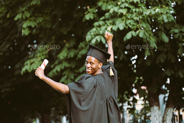Portrait back view of happy black man graduate from university stand ...