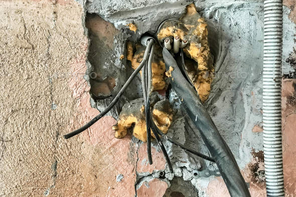 Close up abandoned electrical box with broken wires on ruined filthy ...