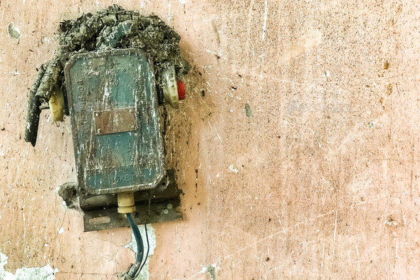 Close up of abandoned rusty electric power distribution box on dirty ...