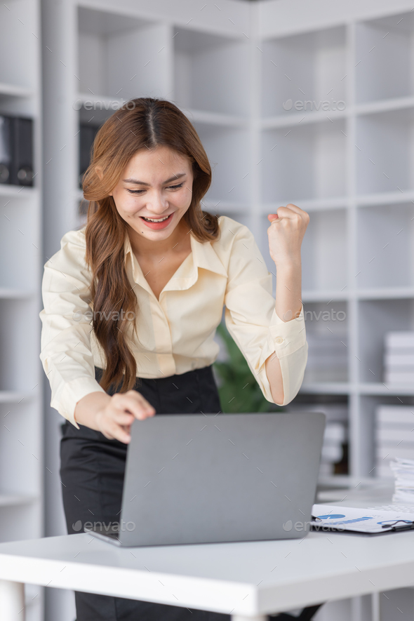 Happy excited successful business asian woman triumphing in office, Portrait of a cheerful Asian ...