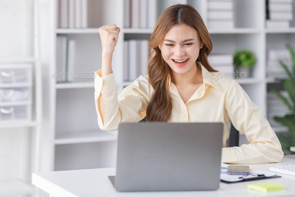Happy excited successful business asian woman triumphing in office, Portrait of a cheerful Asian ...