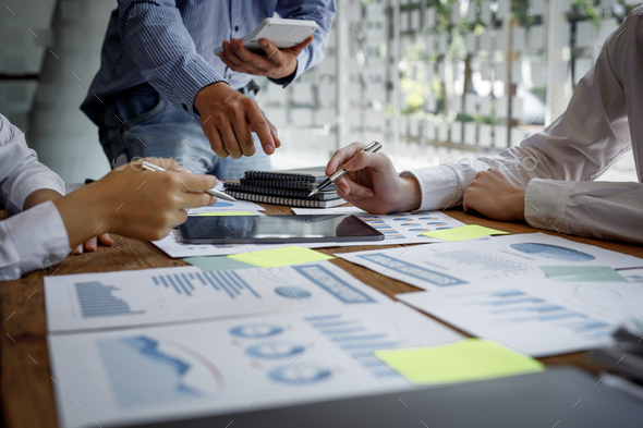 Business People Meeting using chart graph calculator, laptop computer ...