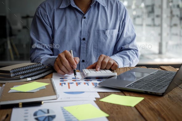 Business People Meeting using chart graph calculator, laptop computer ...