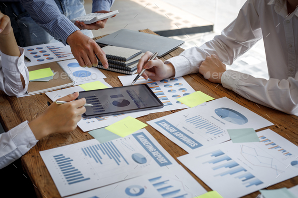 Business People Meeting using chart graph calculator, laptop computer ...