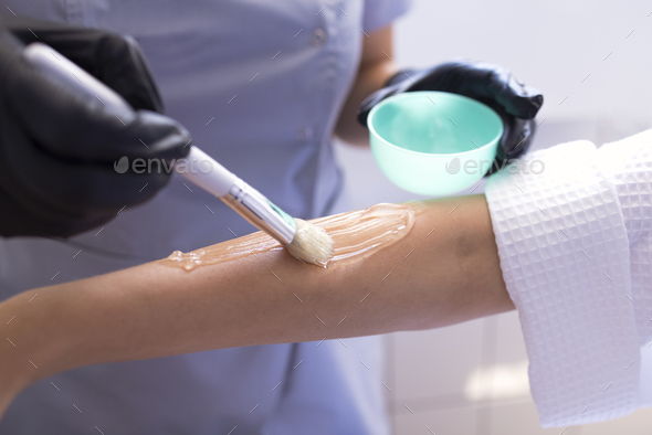 Preparation of clients hand before laser hair removal procedure in spa ...