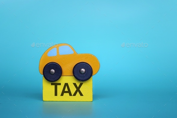 Toy car on top of wooden cube with text TAX. Copy space for text. Stock ...