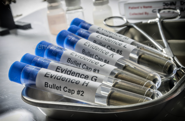 Crime lab, several bullet casings in marked vials, to analyse suspects ...