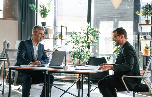 Two men is working on the project. Business people are together in the ...