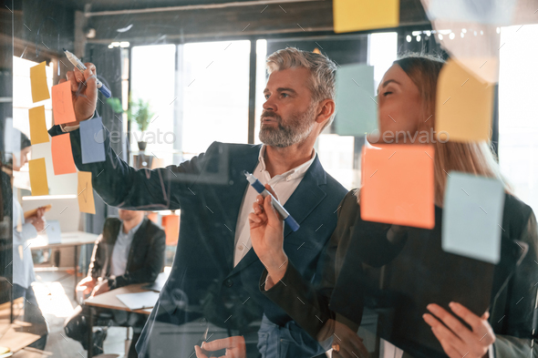 Man and woman are standing. Group of business people are working in the ...