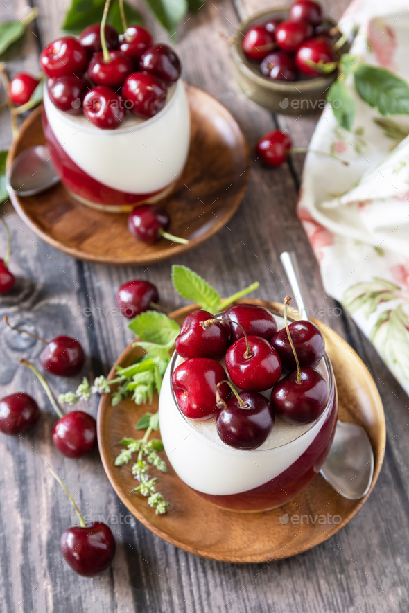 Panna cotta with sweet cherry jelly on a rustic table. Italian dessert ...