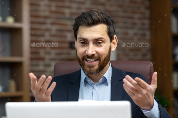 Successful smiling boss talking on video call, man in business suit ...