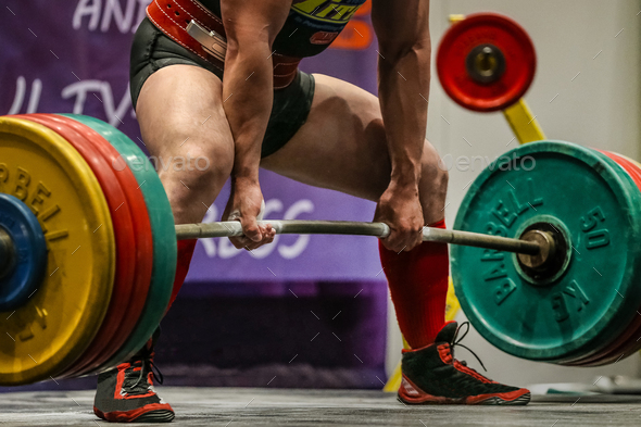 male powerlifter perform deadlift in powerlifting competition, safety ...