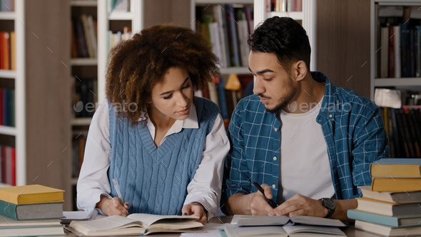 Students do homework in library teamwork working on joint project cute ...