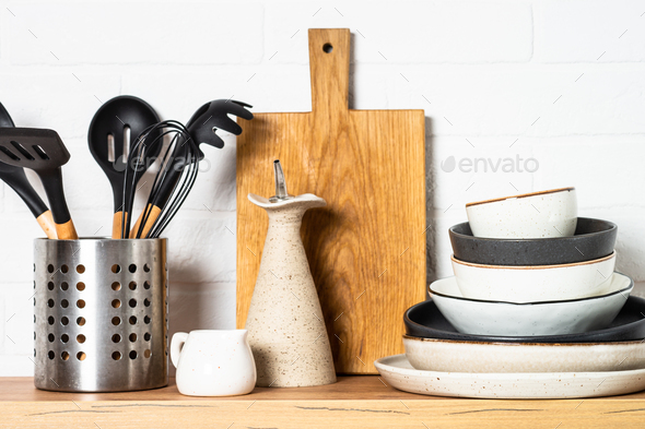 Kitchen table, kitchen utensils, plates, bowls, shakers and wooden ...