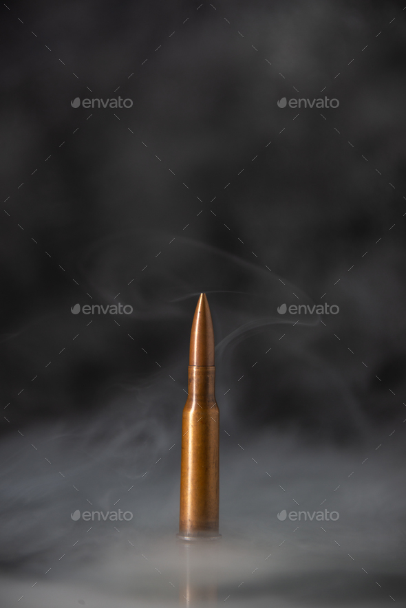 single bullet on dark desk shooting gun tank death war Stock Photo by ...