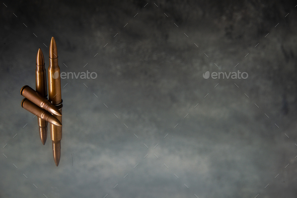 front view of brown bullets on the gray background gun tank death war ...