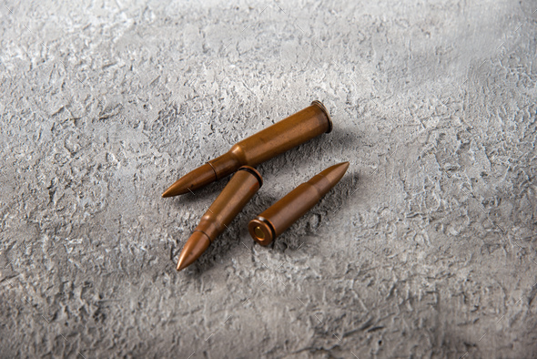 front view of brown bullets on white surface tank war death soldier ...