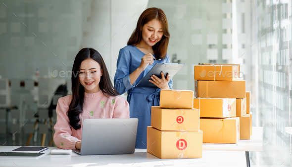 Two Young Asian women are happy and excited after a new order from SME ...