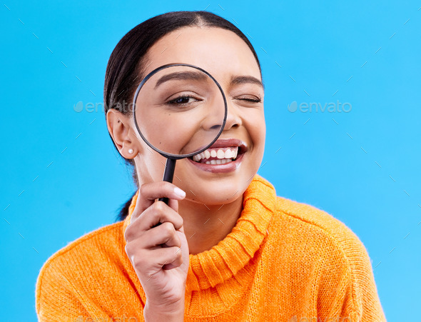Happy, portrait and female with a magnifying glass in a studio for an ...